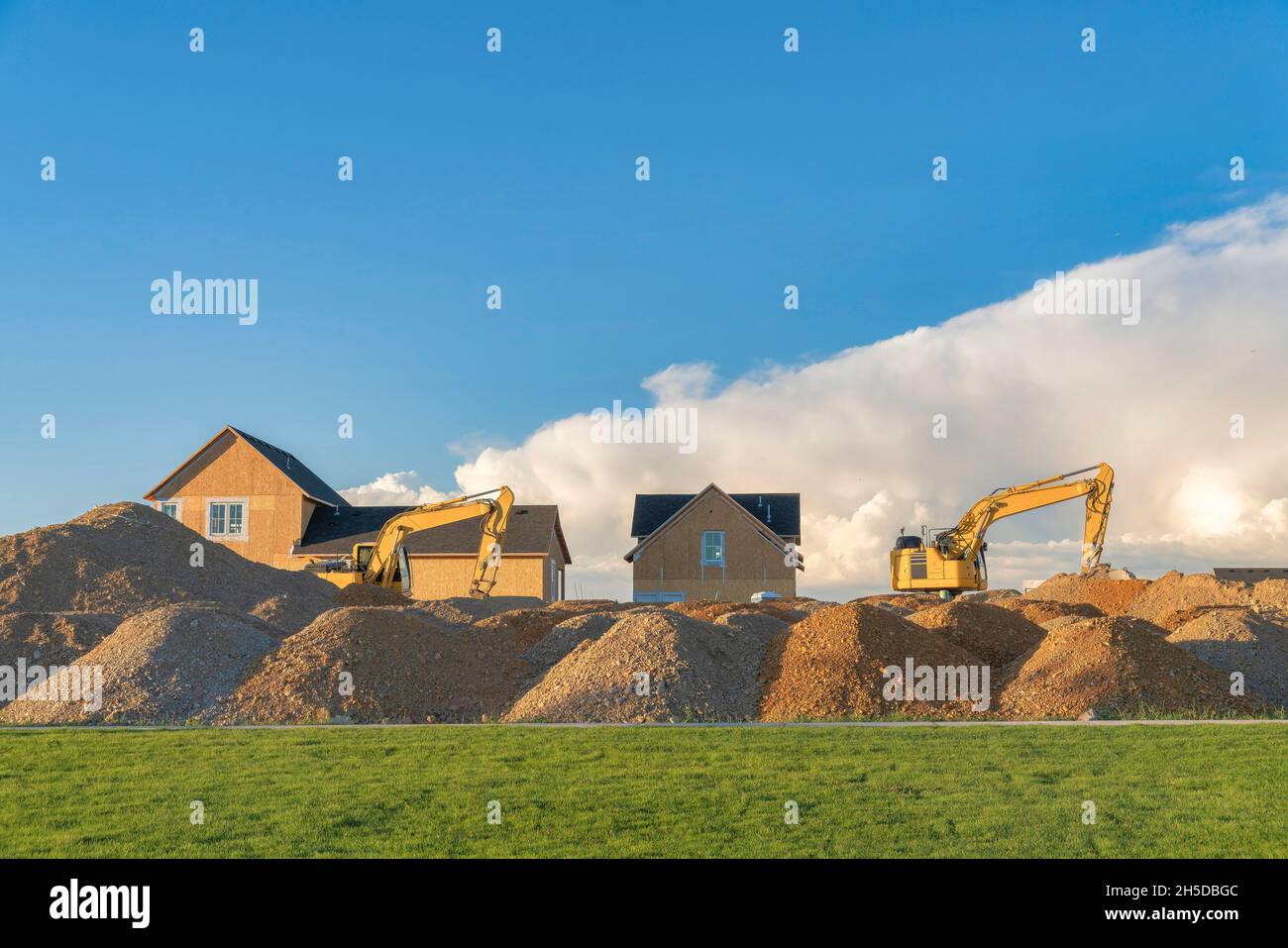 Construction sand piles with two excavators at Utah Stock Photo - Alamy