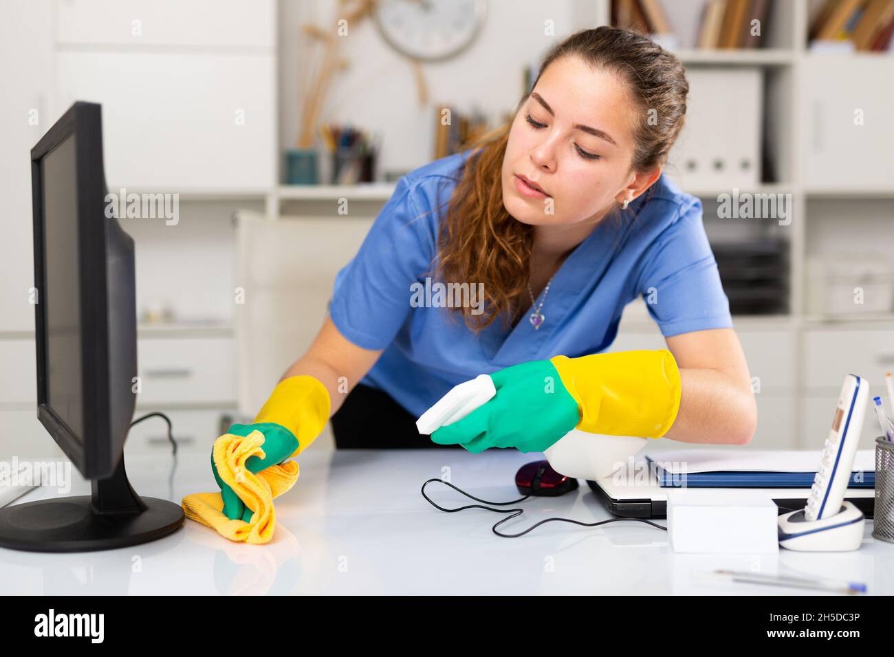 Young friendly cleaning woman in work uniform Stock Photo - Alamy