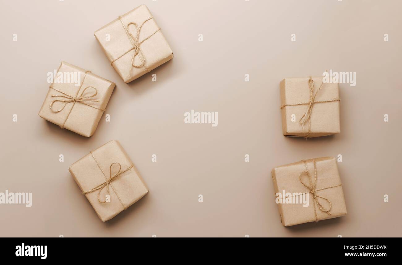 Gifts in eco-friendly paper packaging on a trendy beige background ...