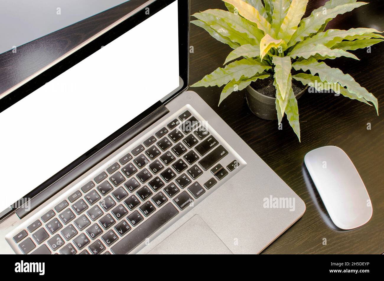 Office desk with laptop computer, mouse Stock Photo - Alamy