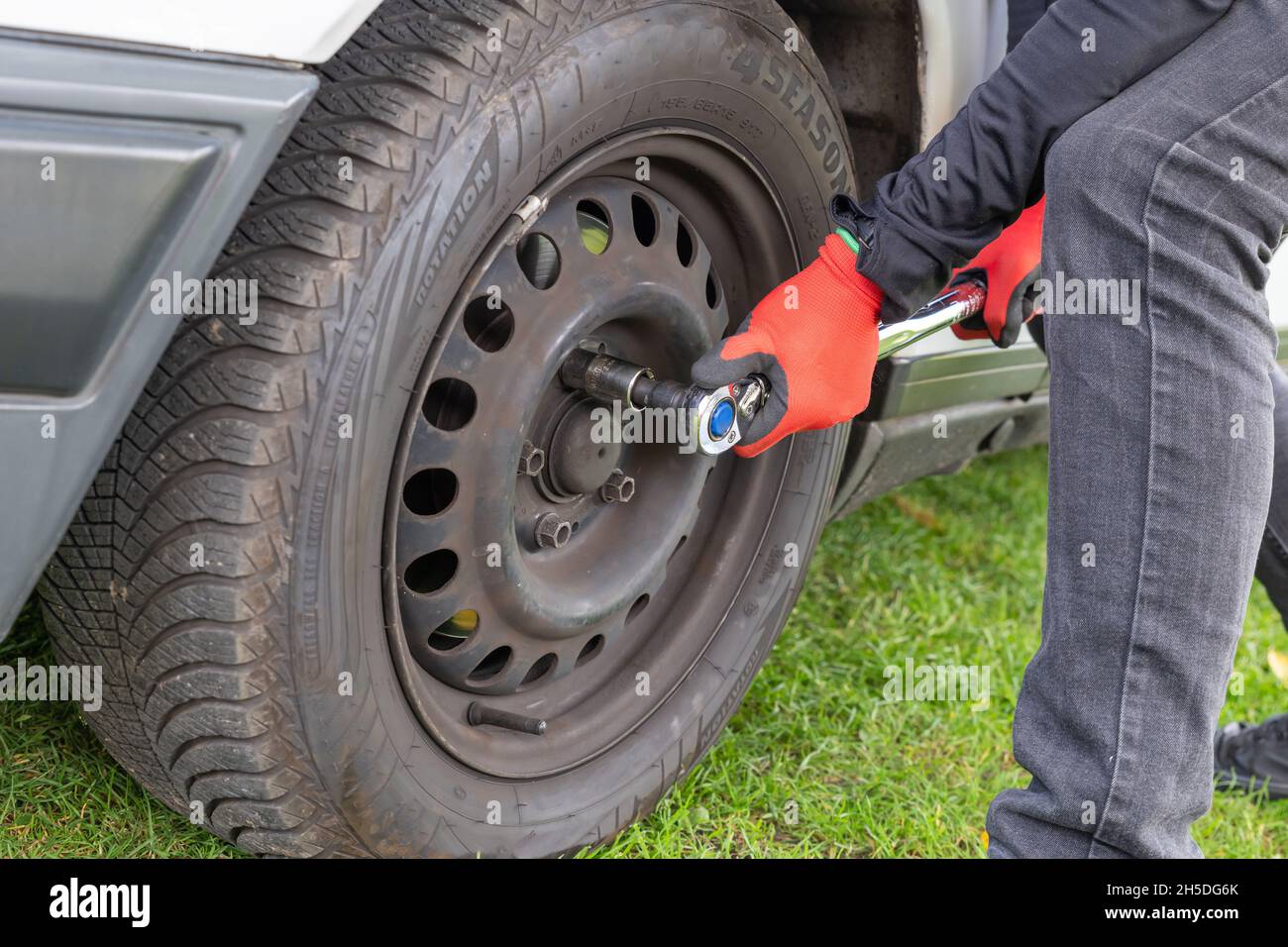 Changing the tyres of a car. All weather tyres Stock Photo - Alamy