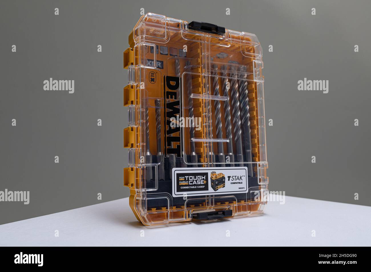 Photo shot of yellow and transparent kit box with drills for drilling ...