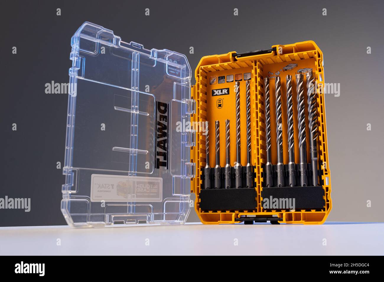 Closeup photo shot of open yellow and transparent kit box with drills ...