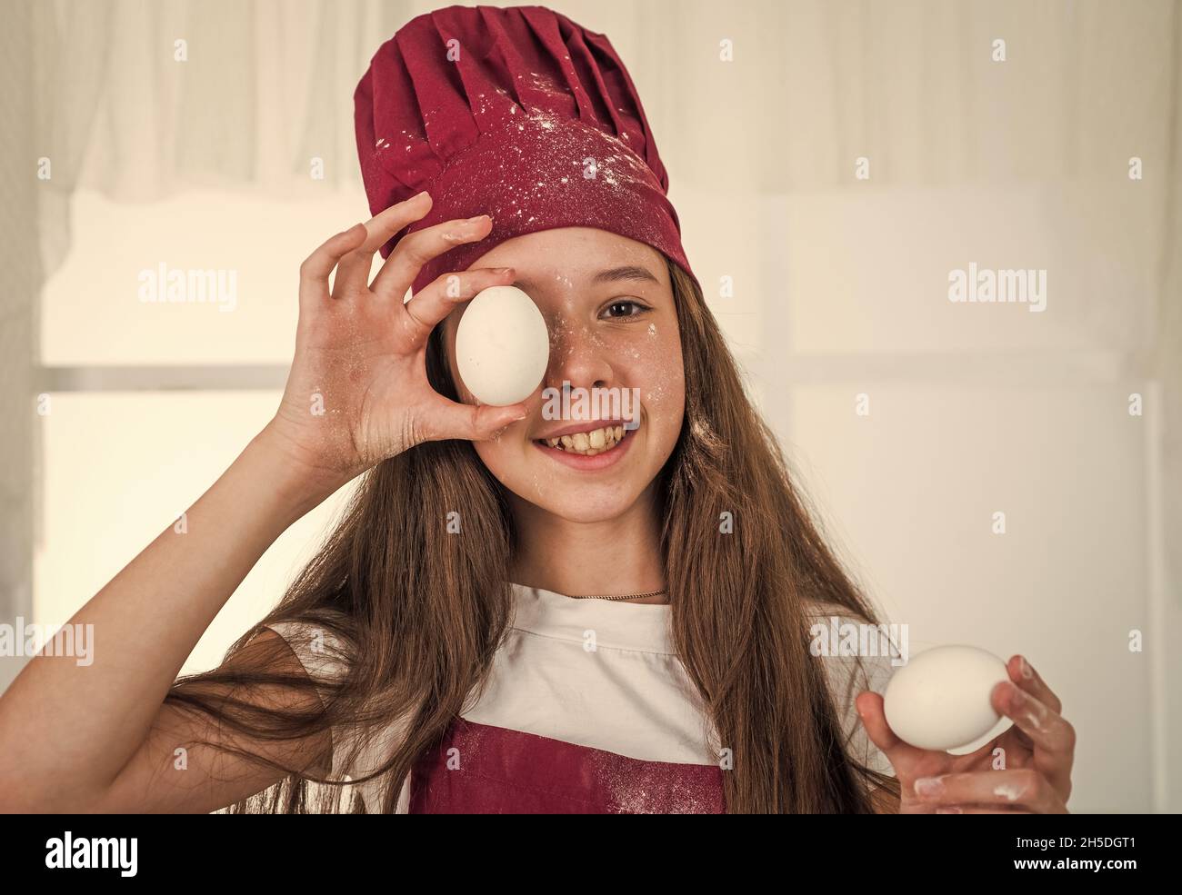 girl with eggs in uniform of cook, food Stock Photo - Alamy