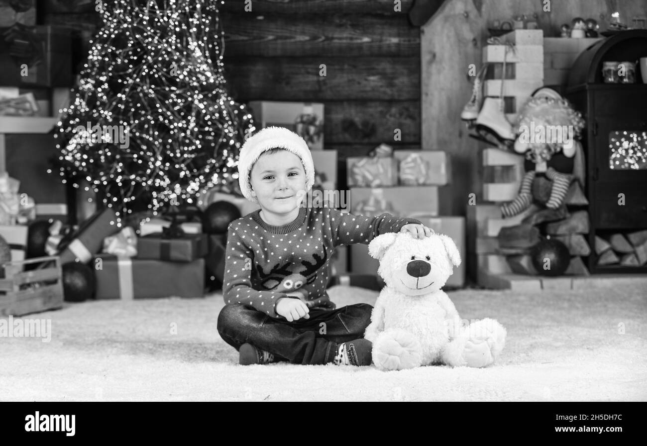 Cute baby. Little boy play near christmas tree. Kid fun home. Merry ...