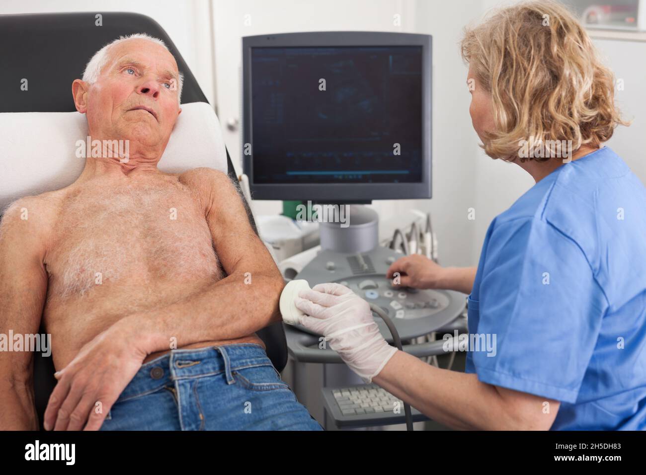 Doctor using ultrasound scan examining patient in hospital Stock Photo ...