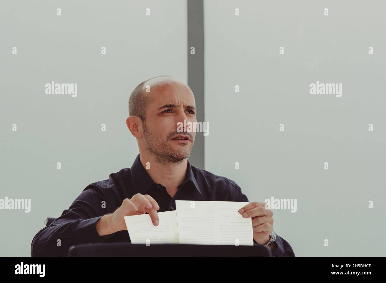 People holding paper sitting in office Stock Photo - Alamy