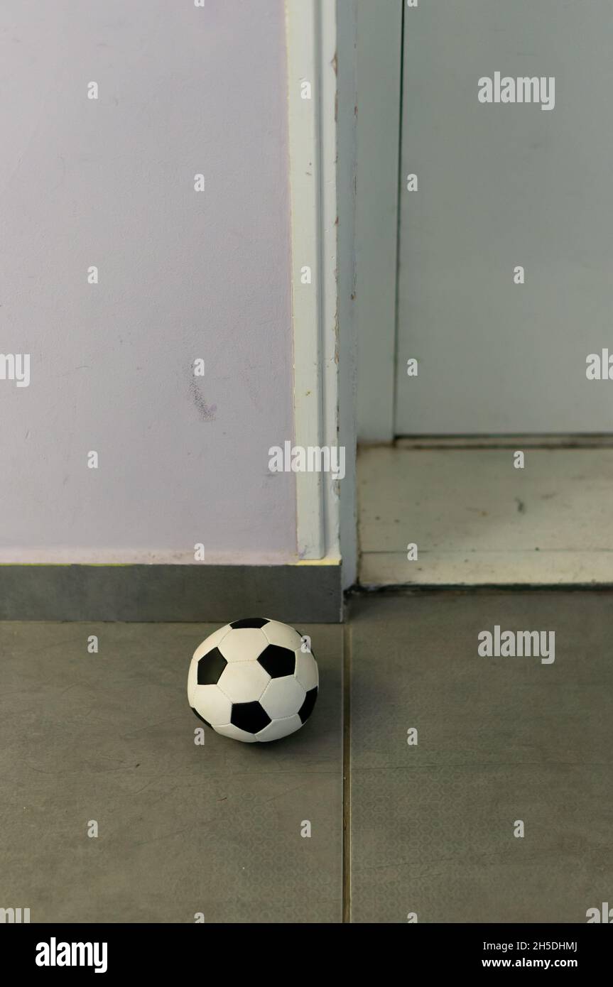 Soccer ball in the gray tiled floor inside the home Stock Photo - Alamy