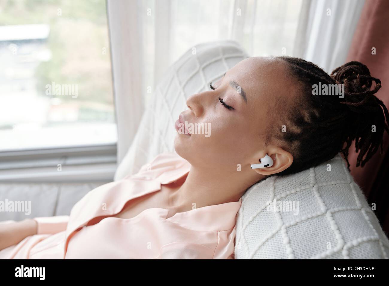 Relaxed face of beautiful woman who fell asleep on her chair at home ...