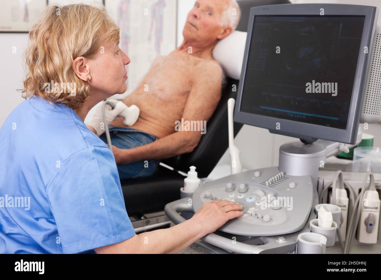 Doctor using ultrasound scan examining patient in hospital Stock Photo ...