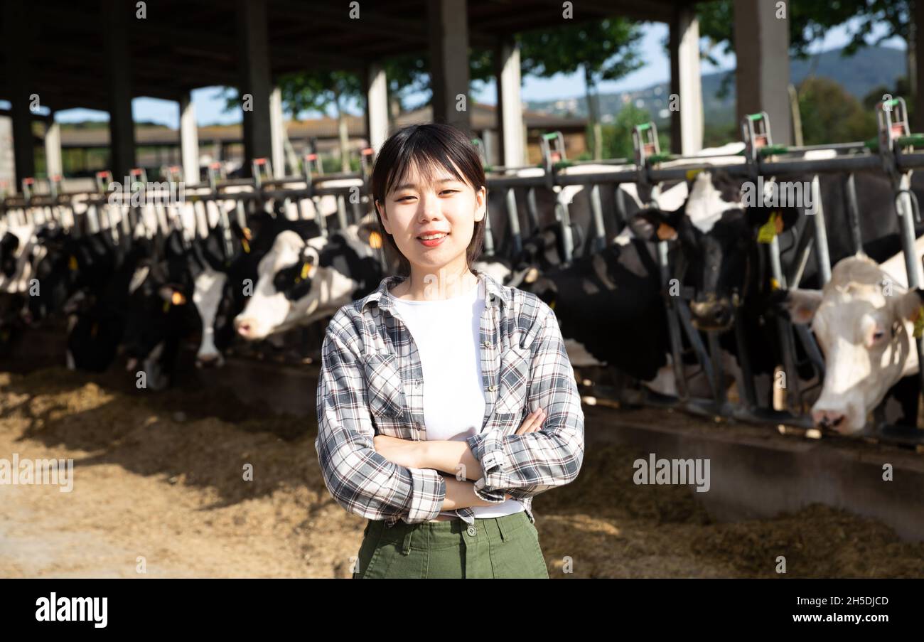 Portrait of chinese female farmer who is standing at her workplace near ...