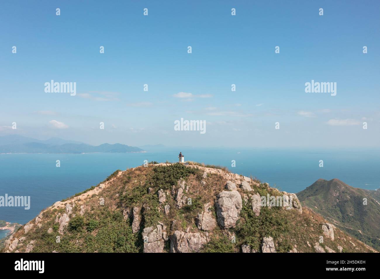 Amazing panorama of Man standing of Sharp Peak, Sai Kung, Hong Kong ...