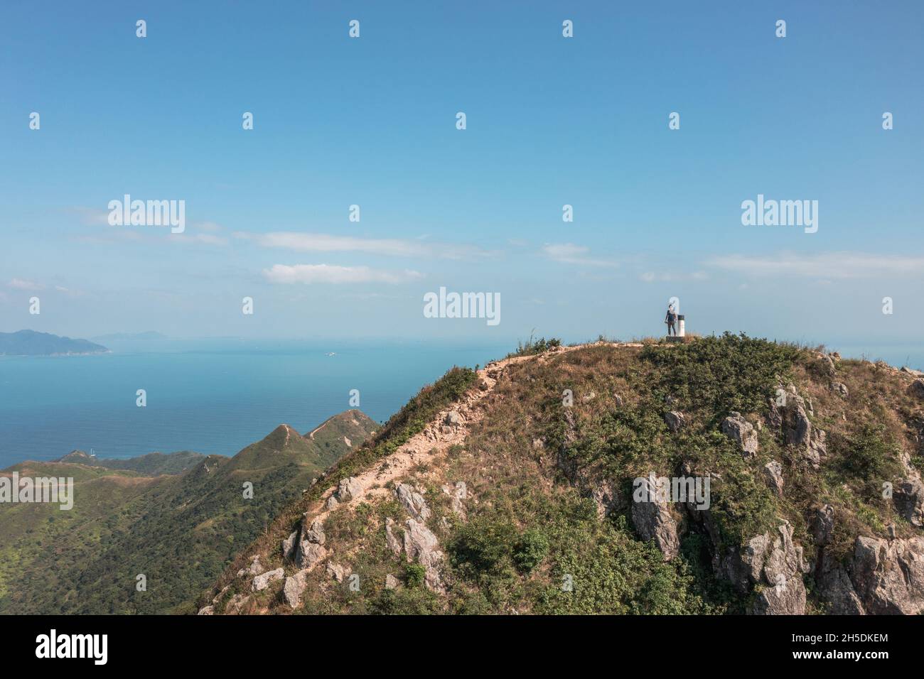 Amazing panorama of Man standing of Sharp Peak, Sai Kung, Hong Kong ...