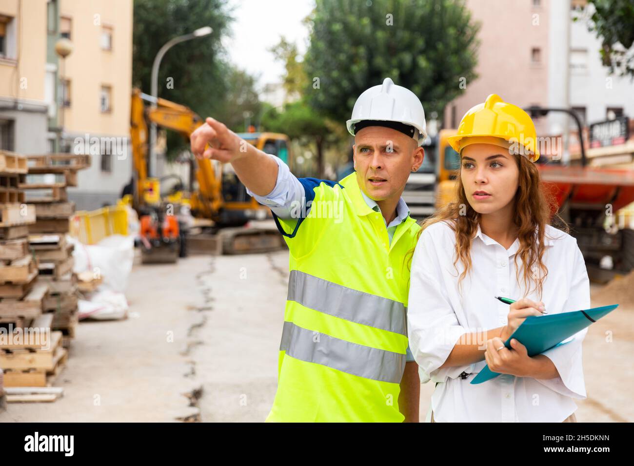 Master builder and architect talking in construction area Stock Photo ...