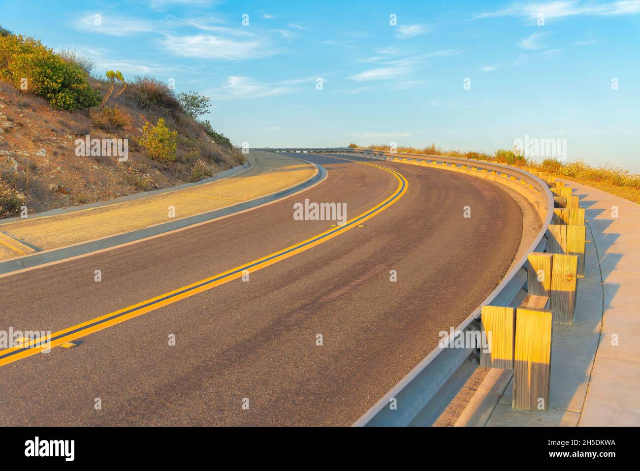 Corner road near the cliff with metal barriers at San Diego, California ...