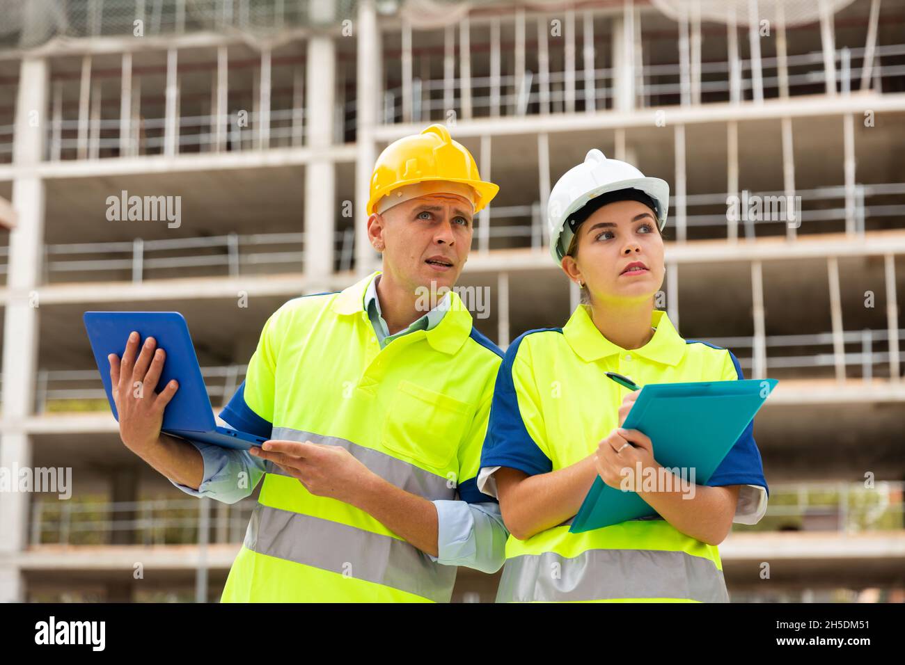 Two builders planning their work in construction plant Stock Photo - Alamy