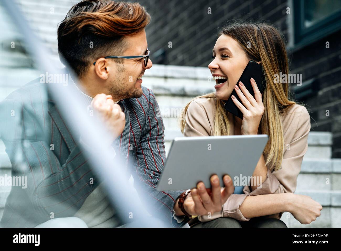 Two creative business people working on social media strategy using a ...