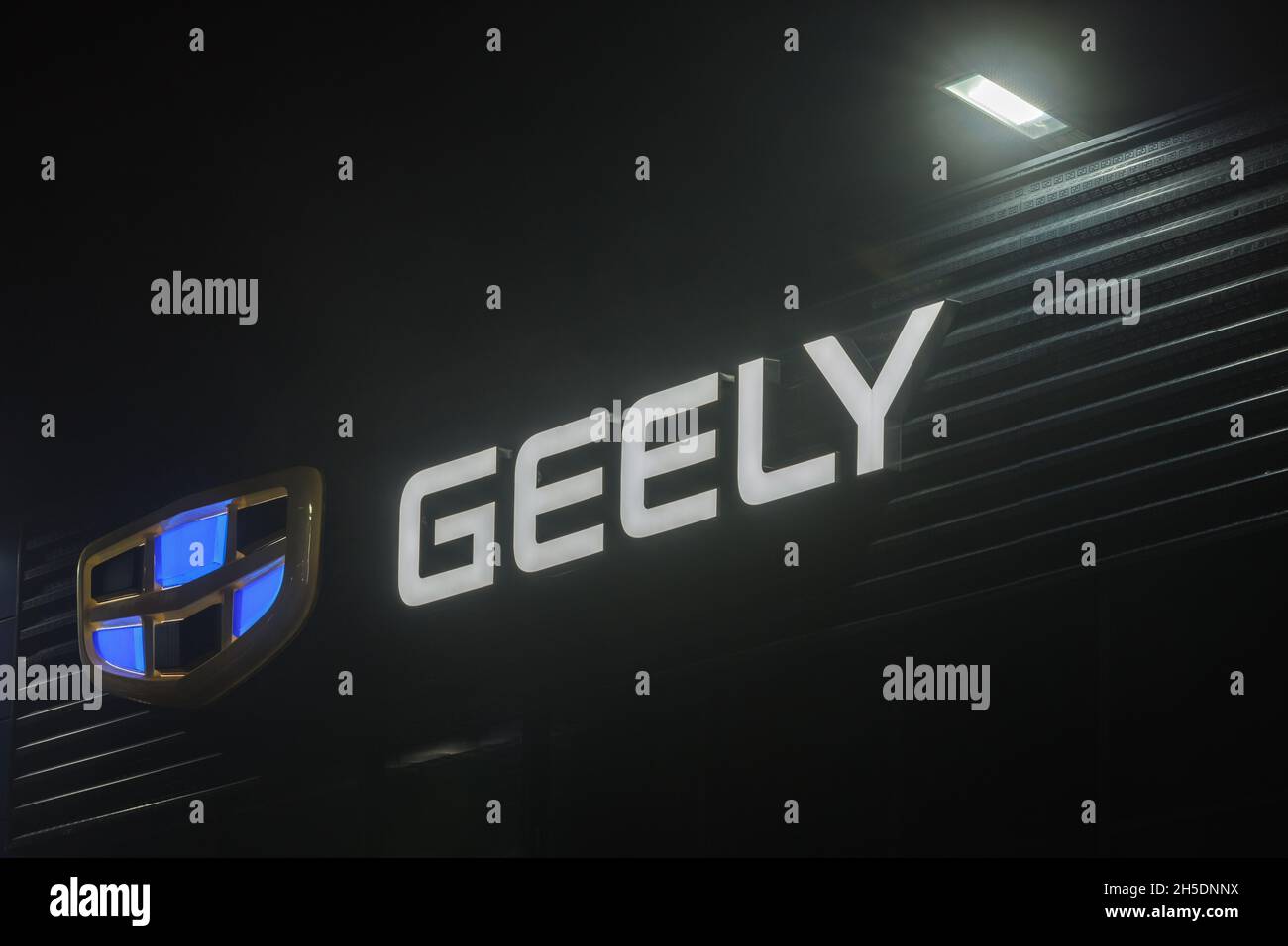 Geely logo on car dealership building at foggy night - Geely is one of ...