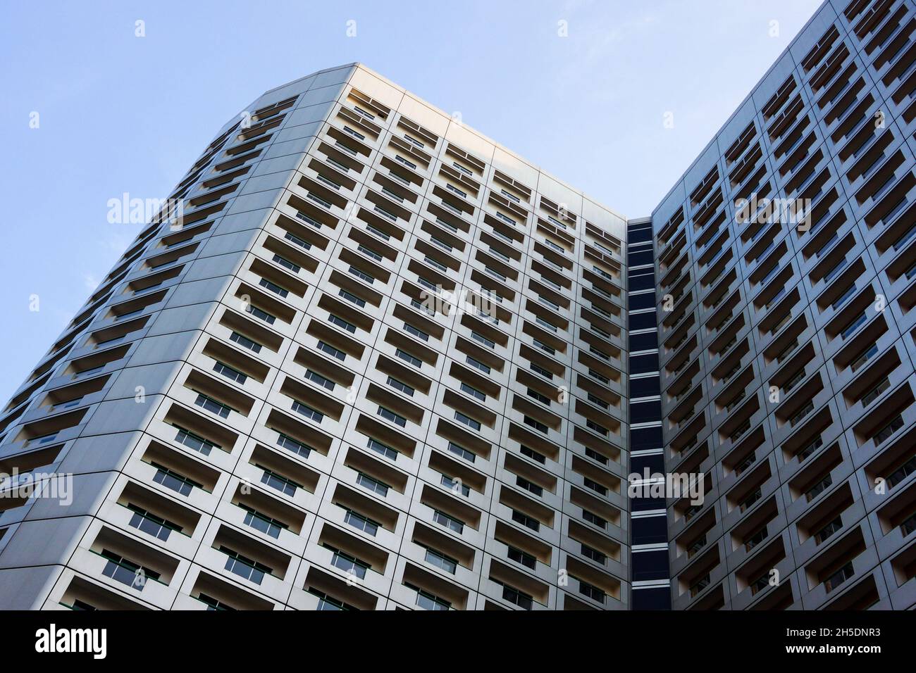 View from below Raffles City Singapore complex building with clear blue ...
