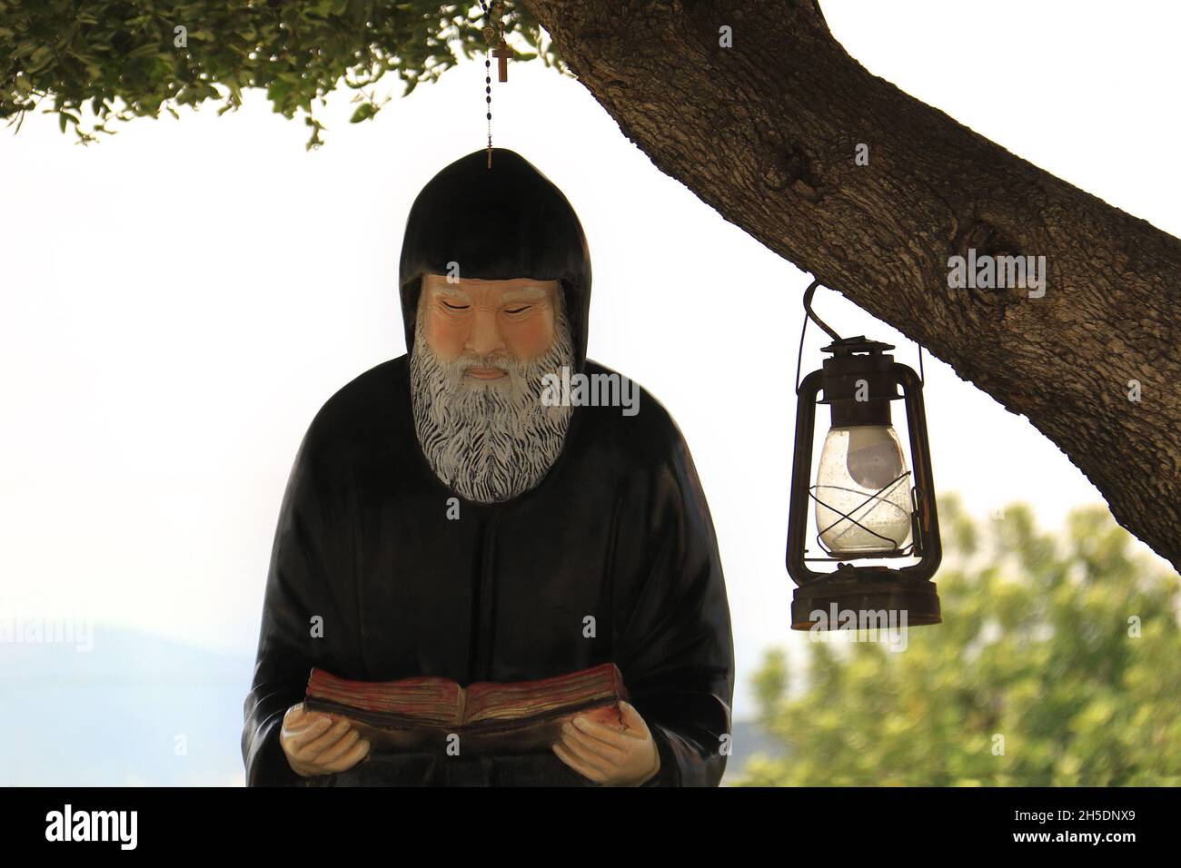 A statue of the Lebanese Saint Mar Charbel reading a book Stock Photo ...