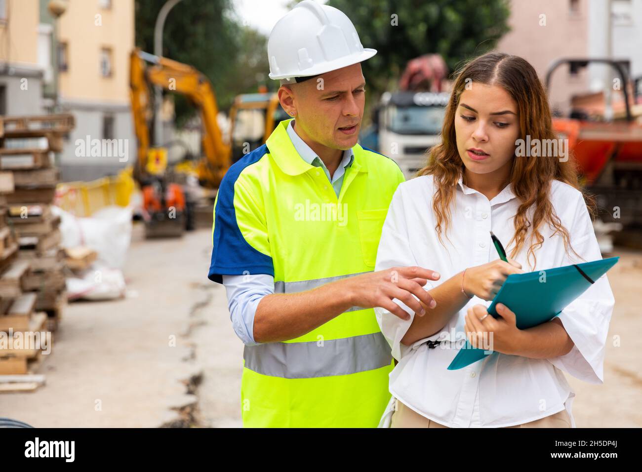 Civil engineers checking work process in construction site Stock Photo ...