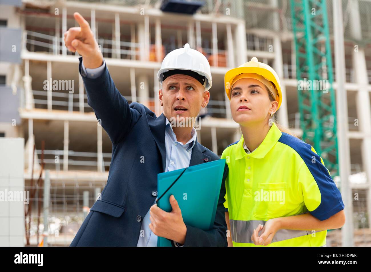 Civil engineers checking work process in construction site Stock Photo ...