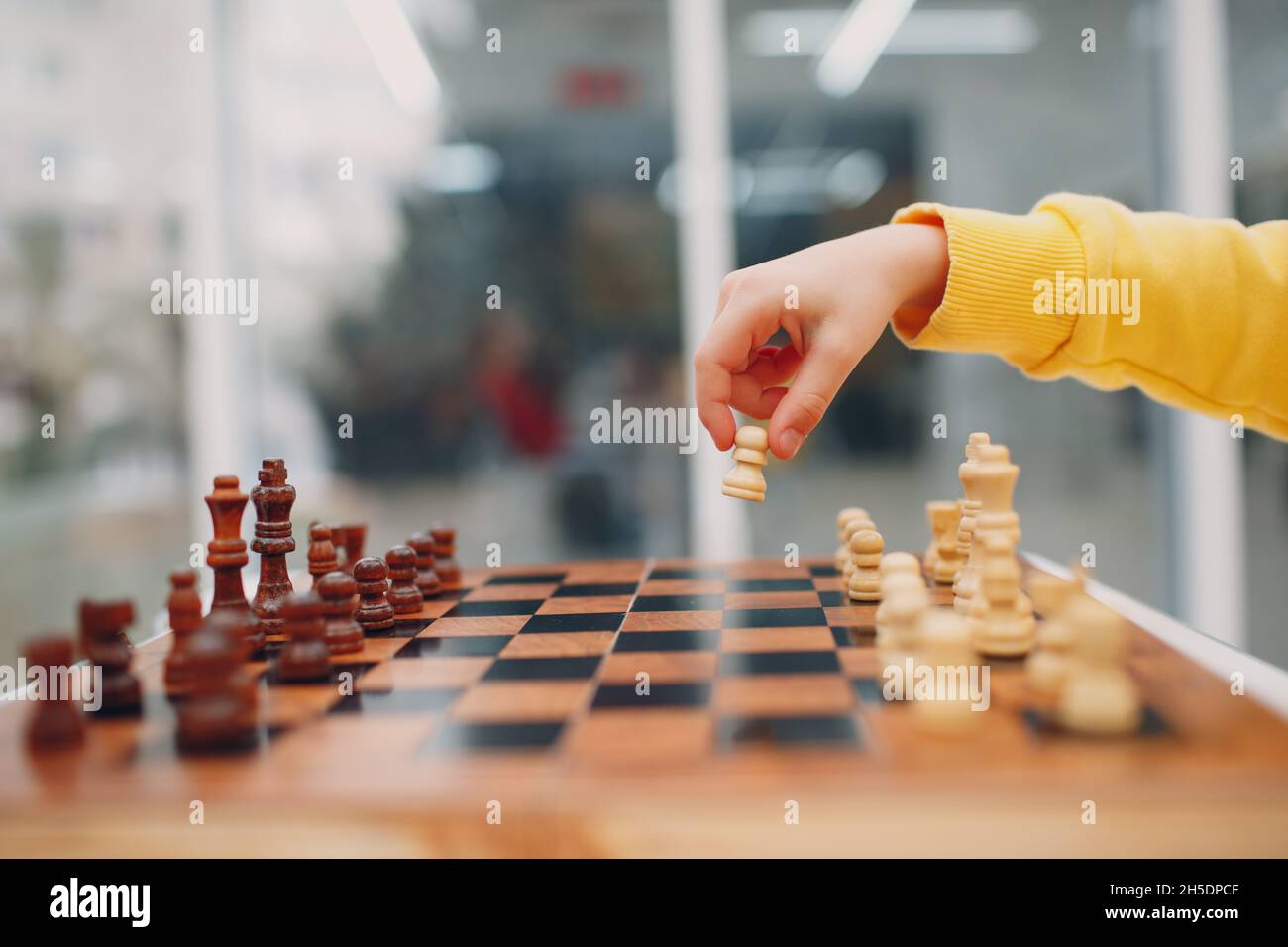 Little kids playing chess at kindergarten or elementary school. Hand ...