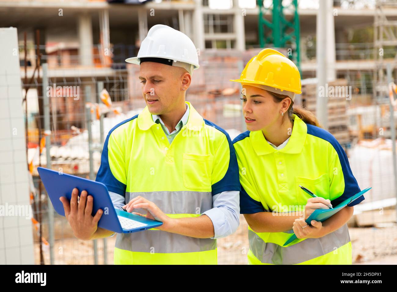 Male and female engineers in construction area Stock Photo - Alamy