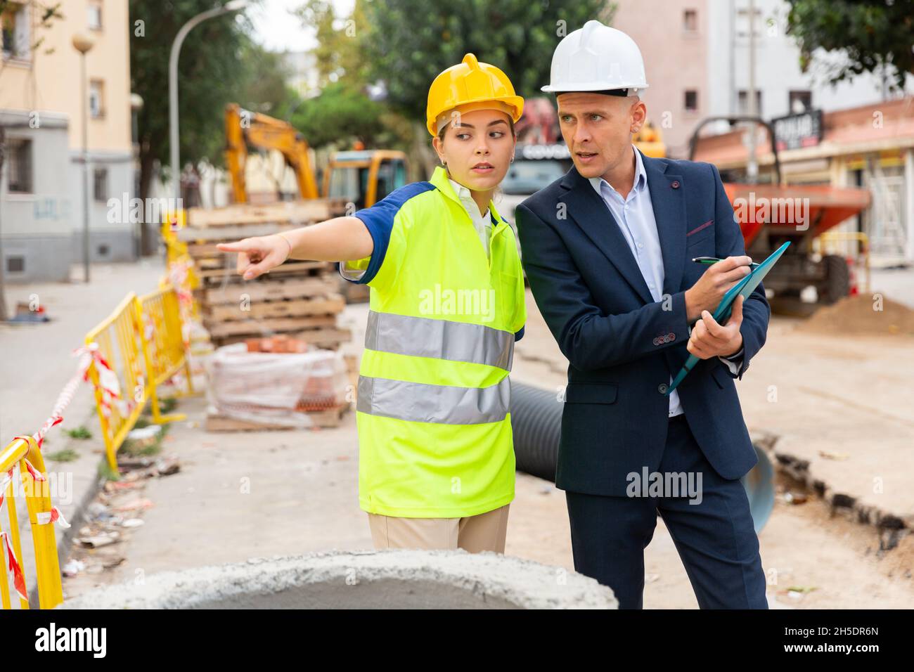 Civil engineers checking work process in construction site Stock Photo ...