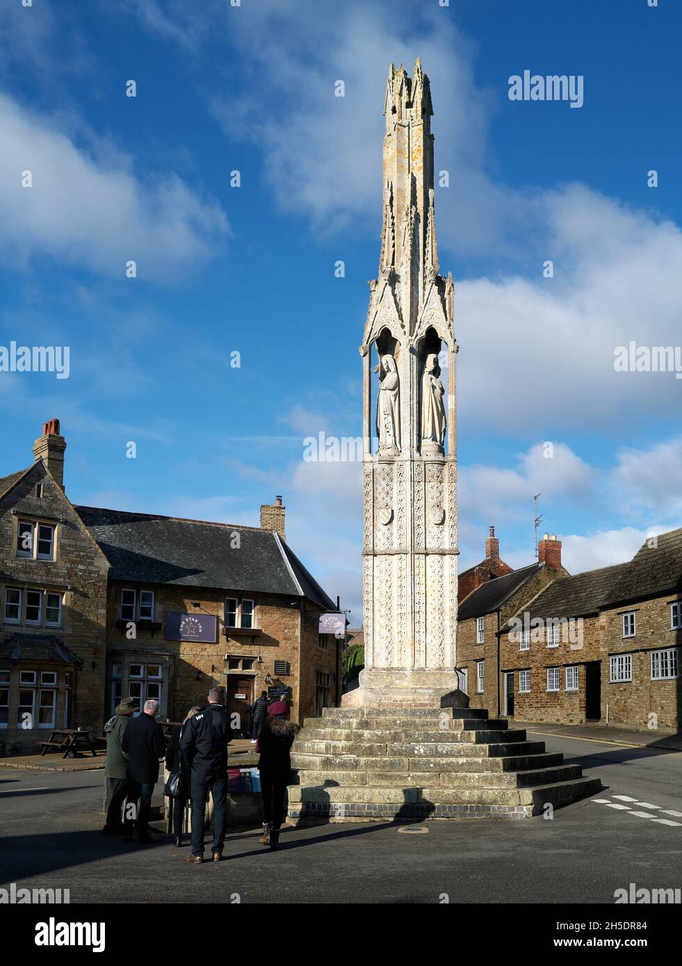 Group of tourists at the triangular Eleanor cross, built by the english ...