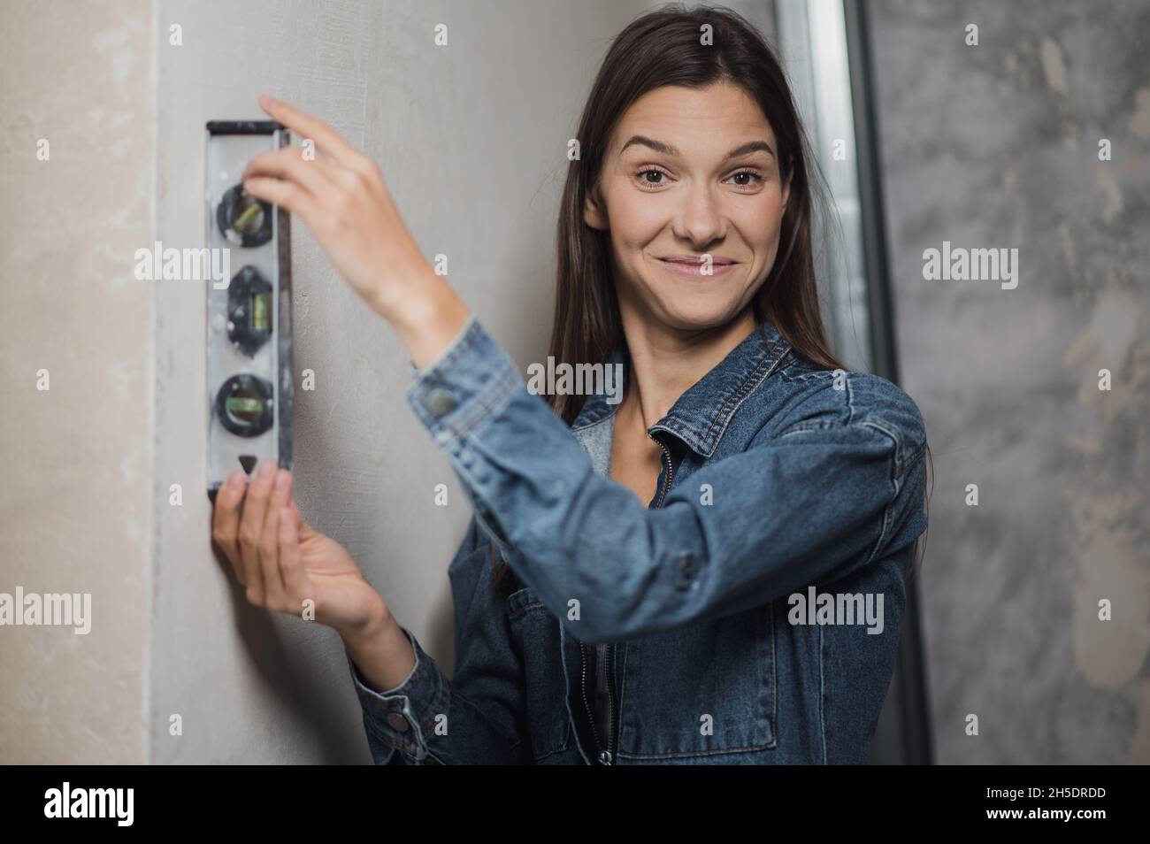 Woman used balance ruler. Measurement of the vertical deviation of the ...
