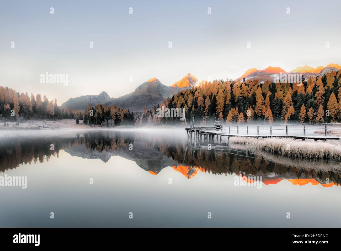 Small alpine lake lake on the swiss alps with dawn fog Stock Photo - Alamy