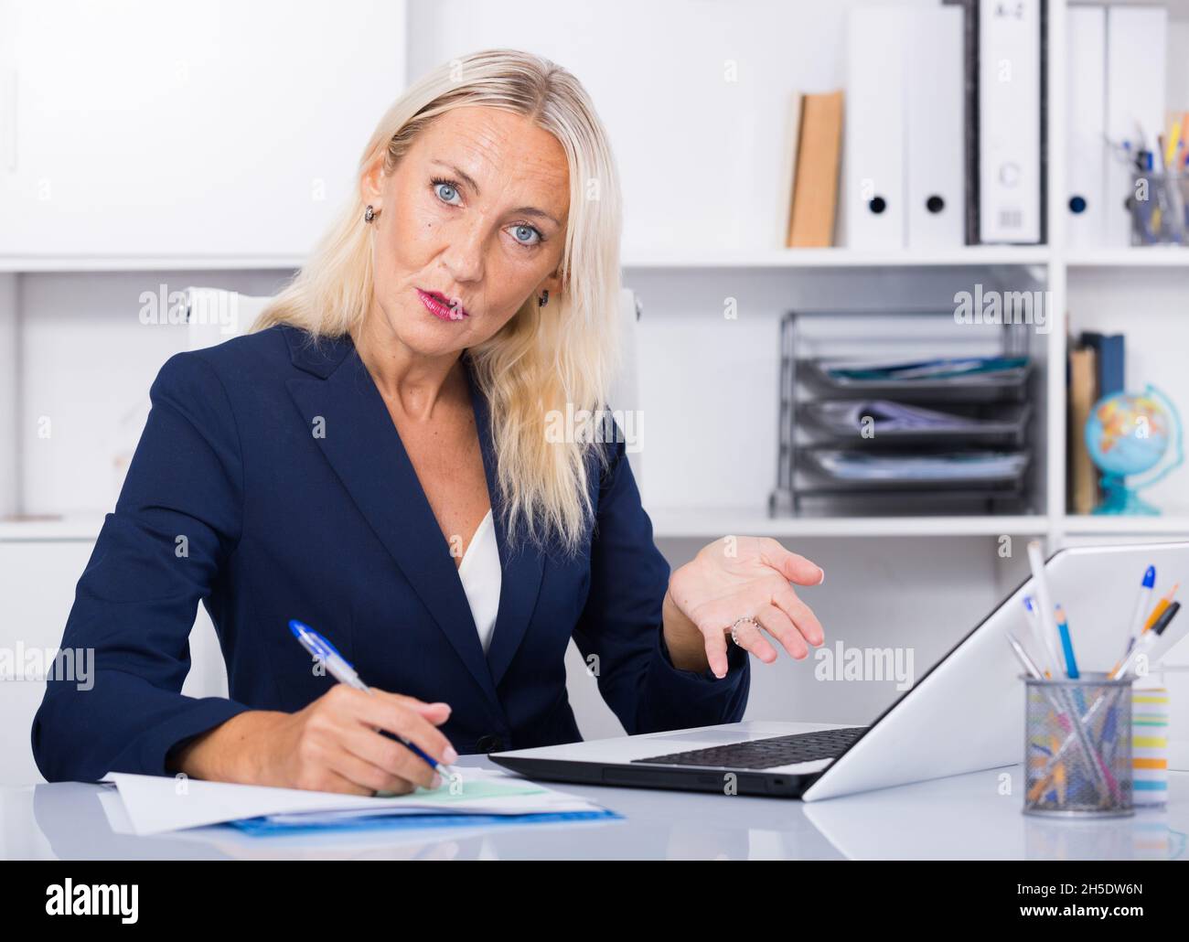 Businesswoman concentrated on work in office Stock Photo - Alamy