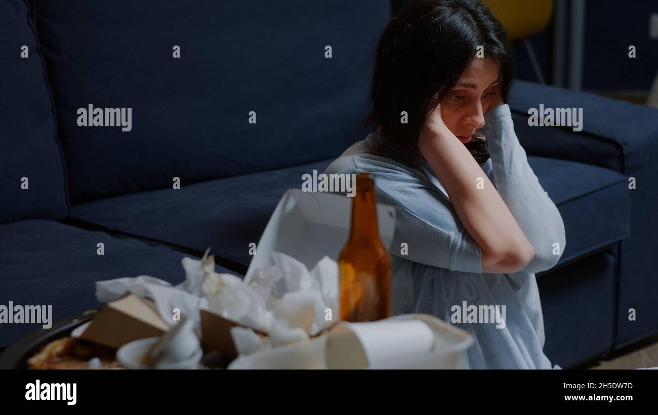 Desperate sad hopeless woman sitting alone on floor swaying having ...