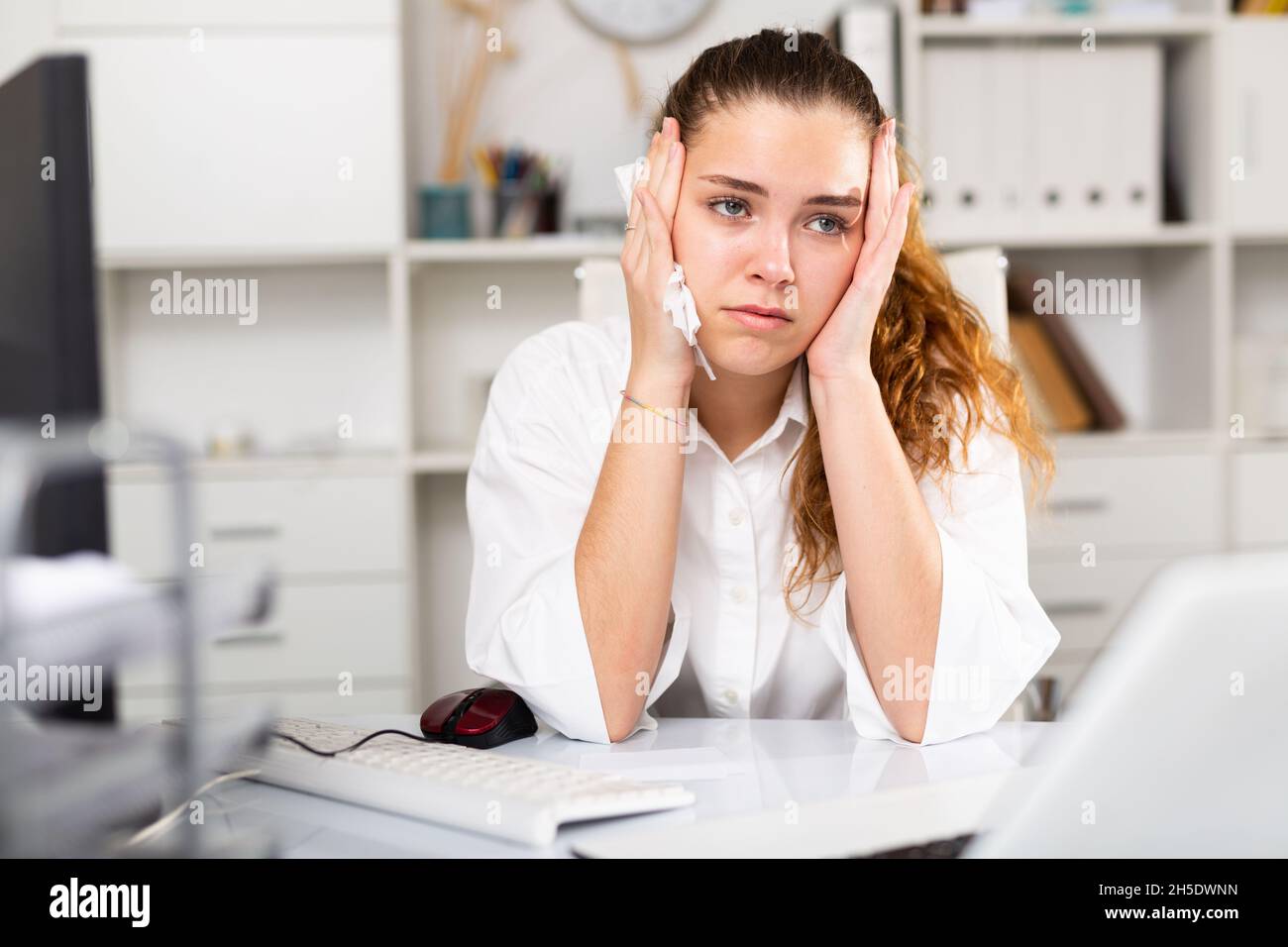 Portrait of distressed female office worker Stock Photo - Alamy