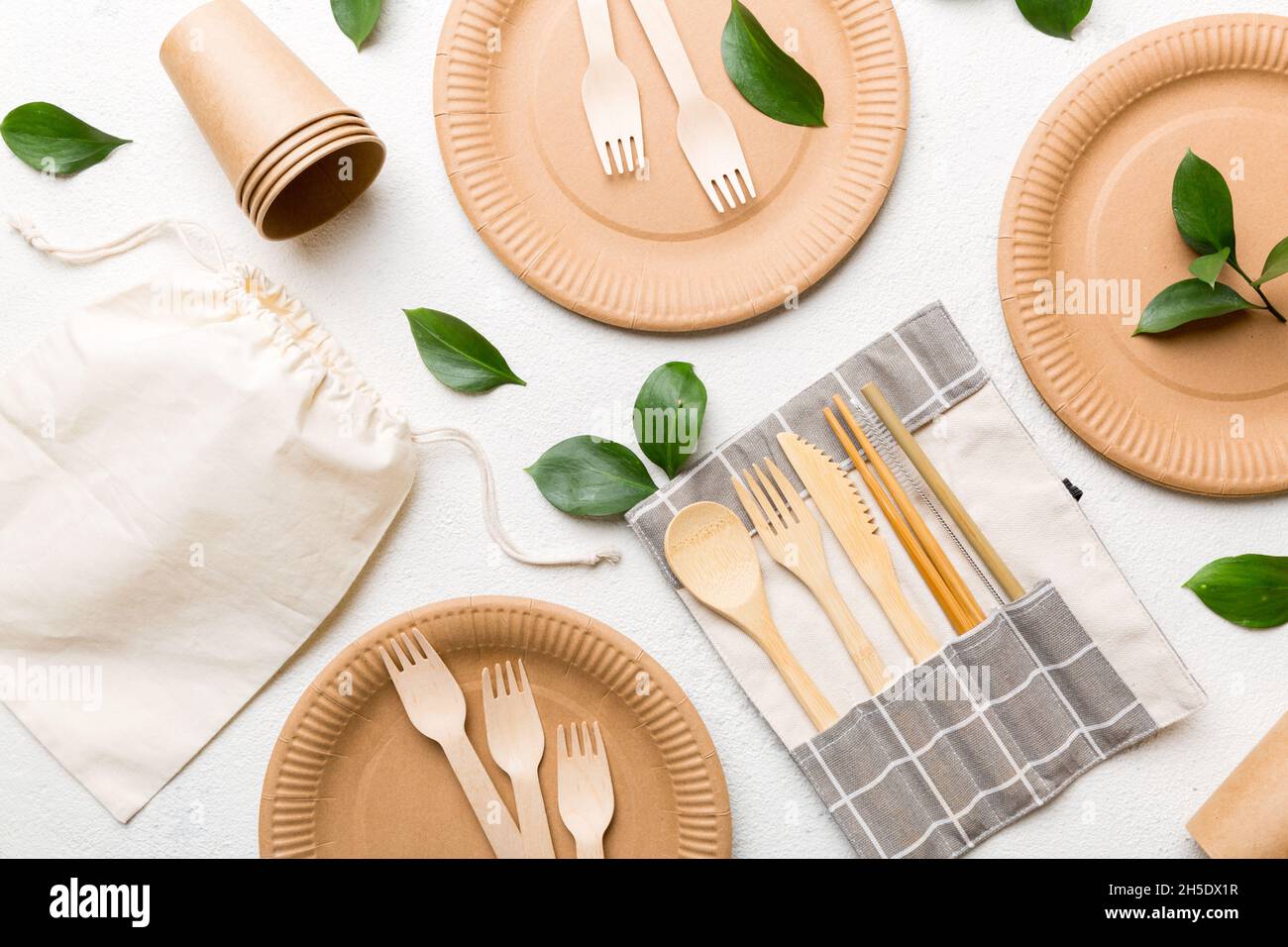 set of empty reusable disposable eco-friendly plates, cups, utensils on ...