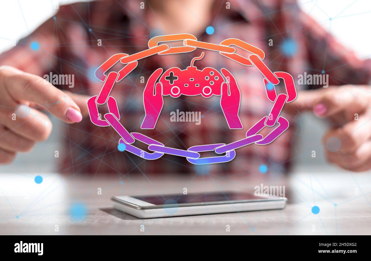 Smartphone with video game addiction concept between hands of a woman ...