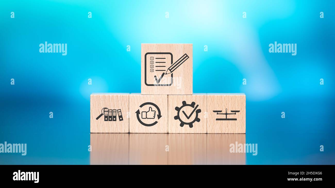 Wooden blocks with symbol of assessment concept on blue background ...