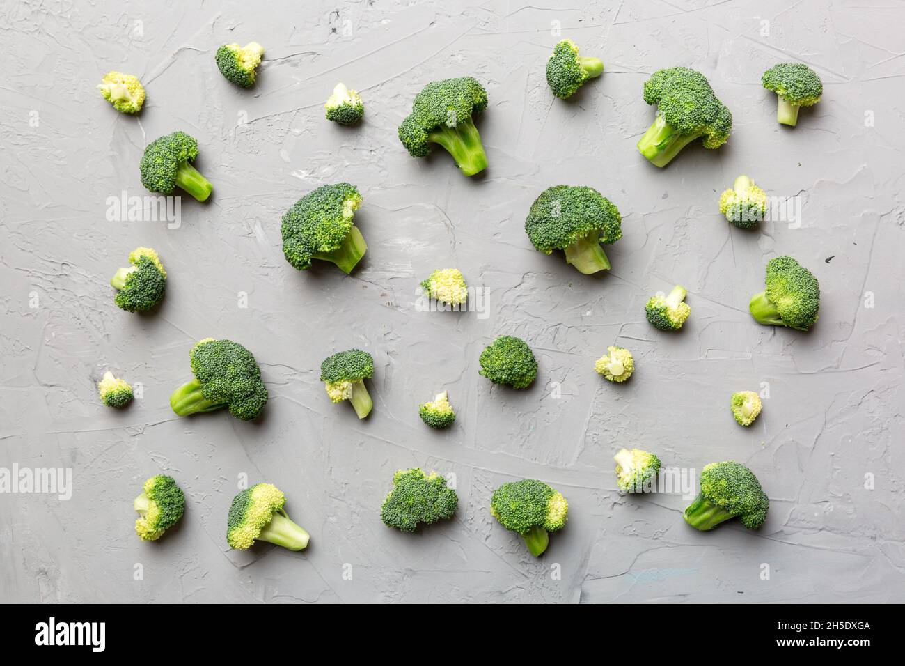 green fresh broccoli background close up on colored table. Vegetables ...