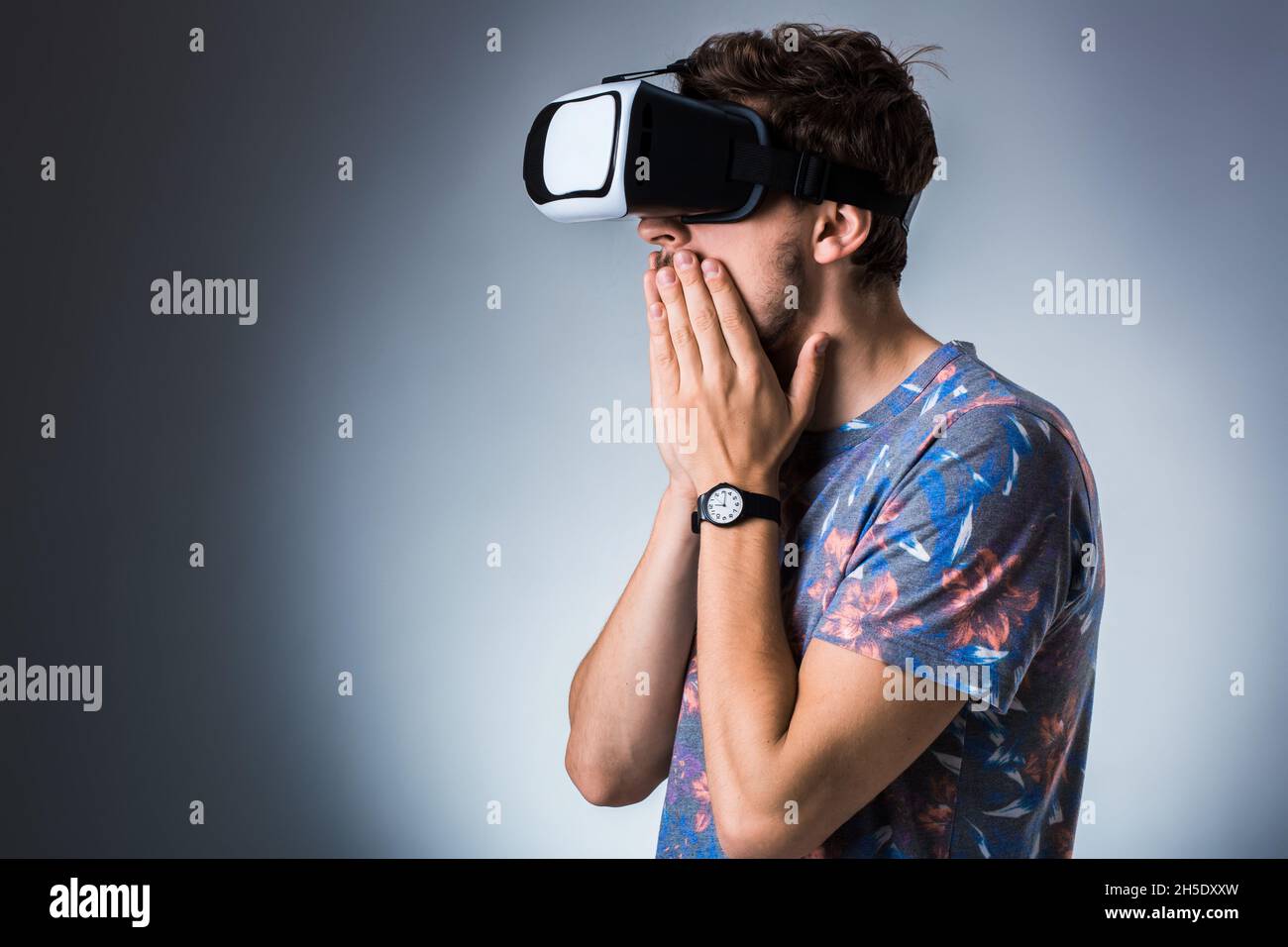 Side view of a young guy using a VR headset. Emotions Stock Photo - Alamy