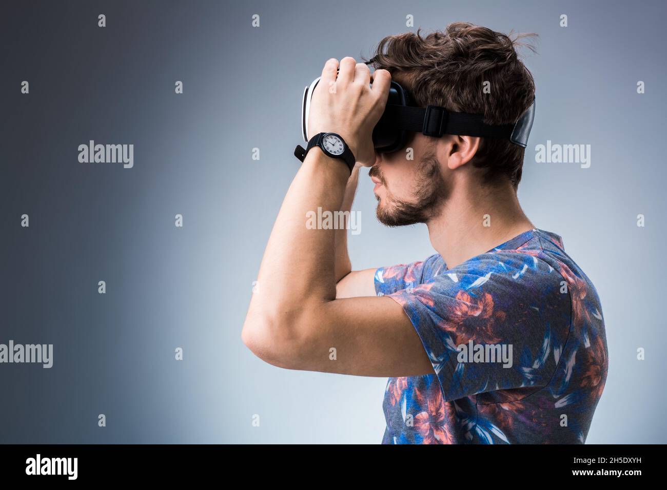 Side view of a young guy using a VR headset. Emotions Stock Photo - Alamy
