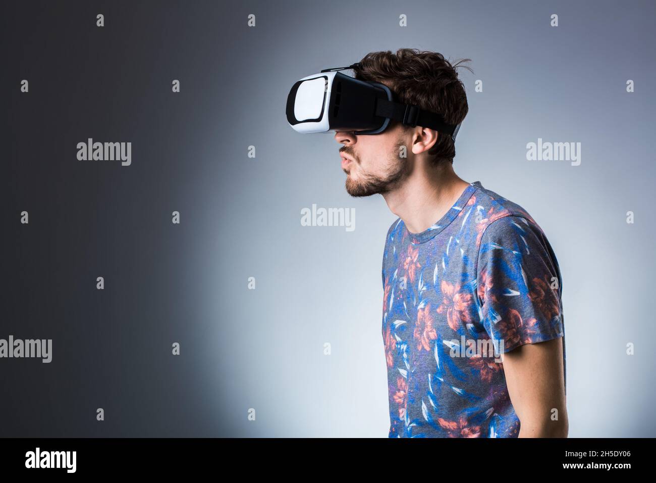 Side view of a young guy using a VR headset. Emotions Stock Photo - Alamy