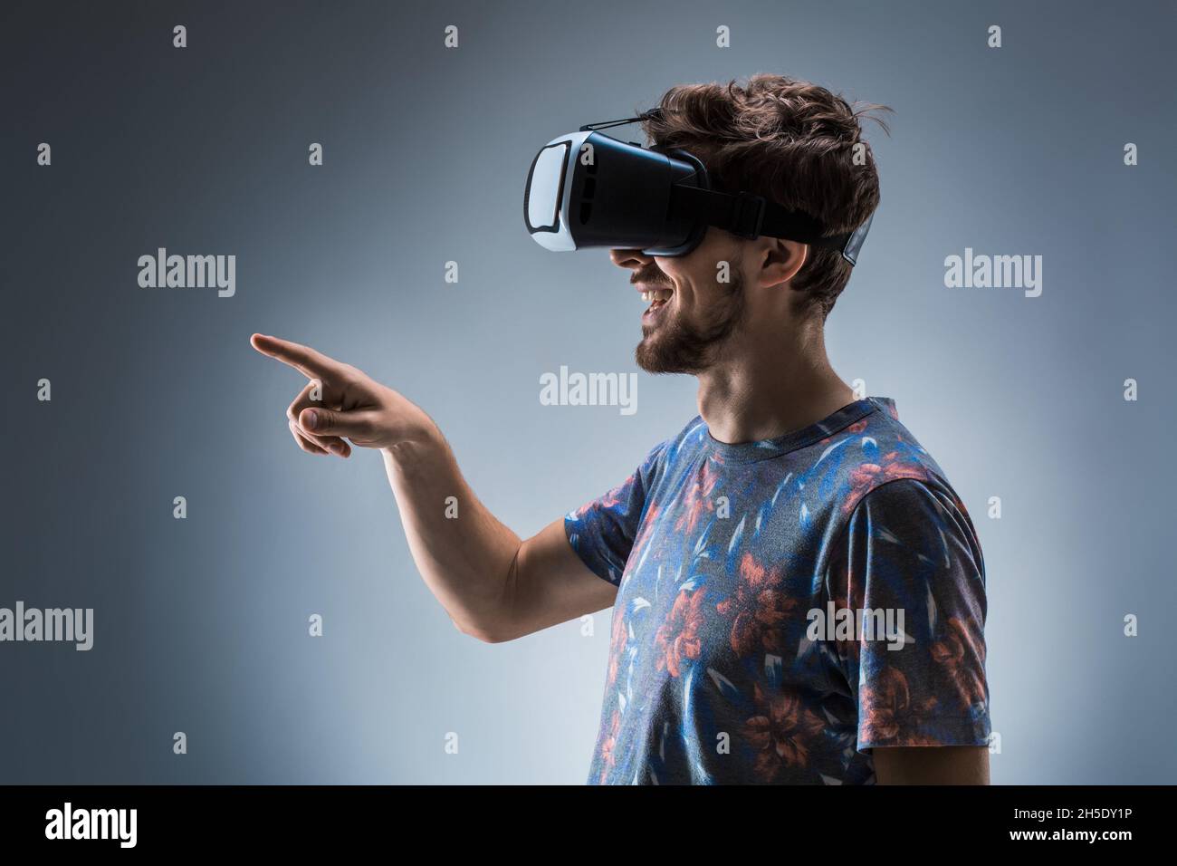 Side view of a young guy using a VR headset. Emotions Stock Photo - Alamy