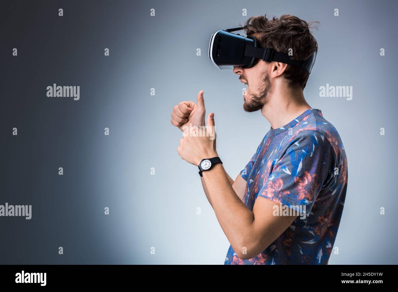 Side view of a young guy using a VR headset. Emotions Stock Photo - Alamy