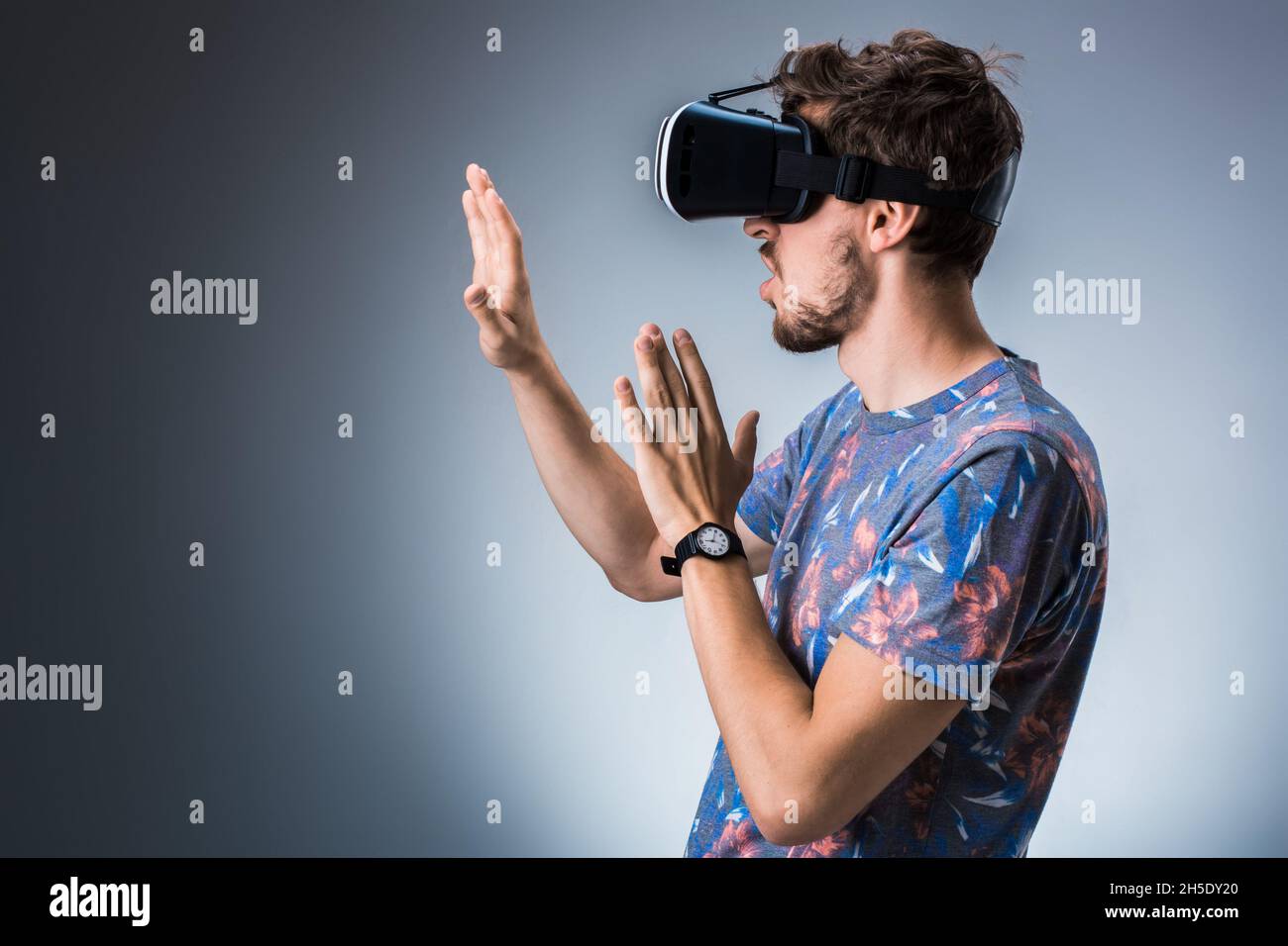 Side view of a young guy using a VR headset. Emotions Stock Photo - Alamy
