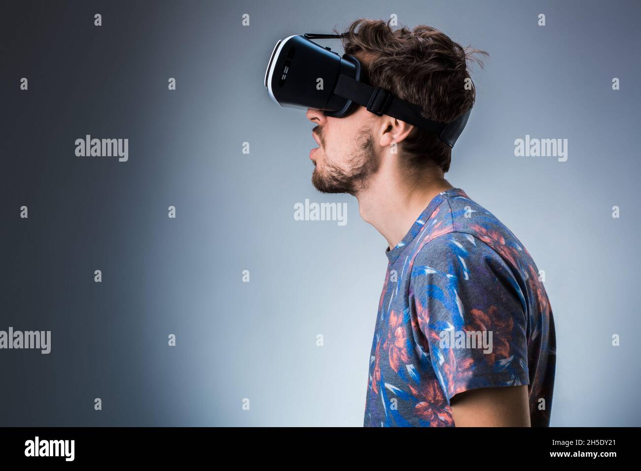 Side view of a young guy using a VR headset. Emotions Stock Photo - Alamy