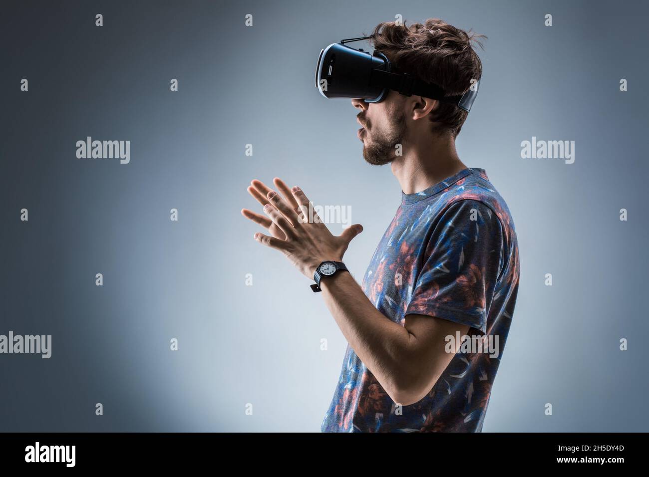 Side view of a young guy using a VR headset. Emotions Stock Photo - Alamy
