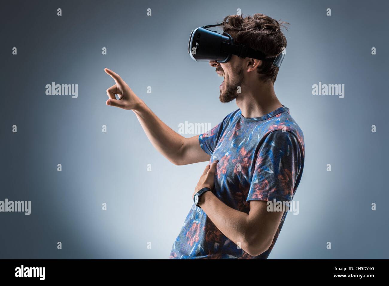 Side view of a young guy using a VR headset. Emotions Stock Photo - Alamy