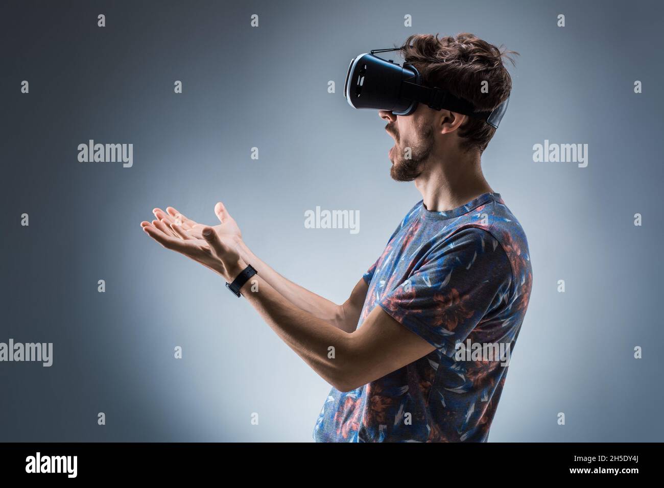 Side view of a young guy using a VR headset. Emotions Stock Photo - Alamy