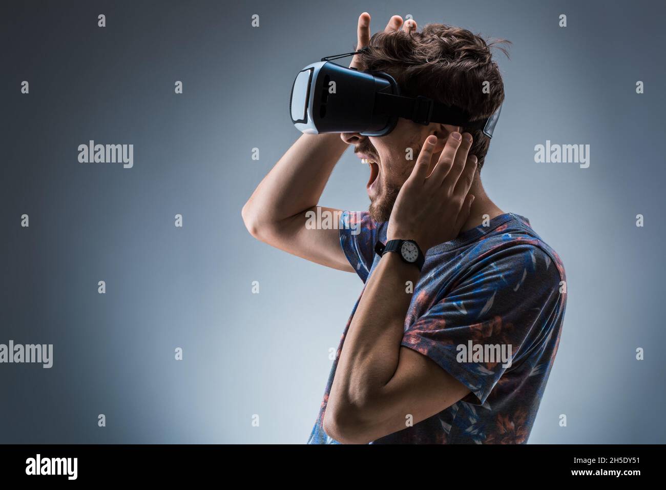 Side view of a young guy using a VR headset. Emotions Stock Photo - Alamy